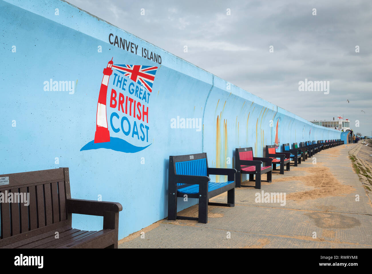 Coast UK seaside, view of benches along the blue sea wall on Canvey ...