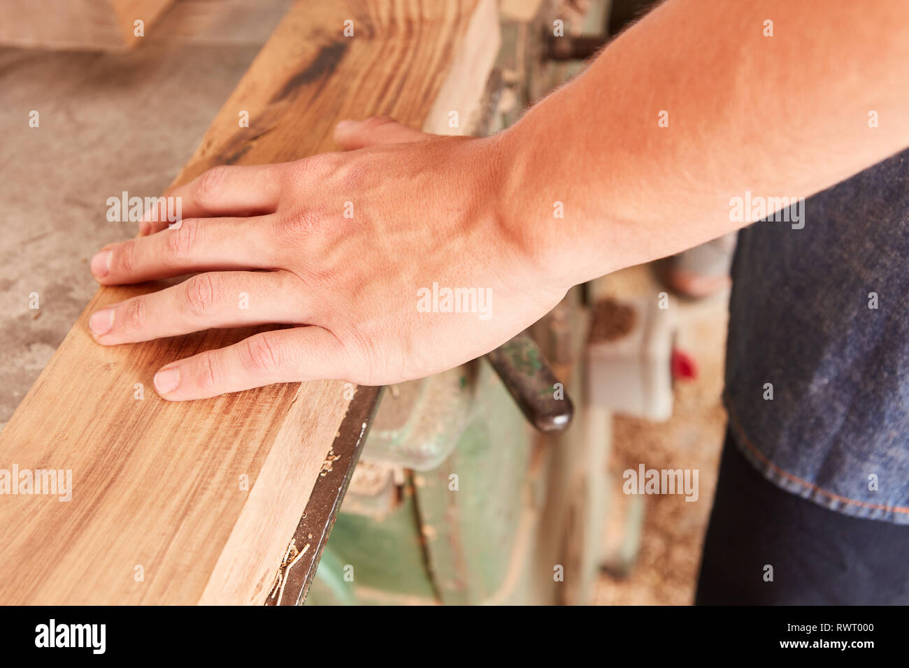 Hand of a carpenter or joiner on a wood beam on the workbench Stock ...