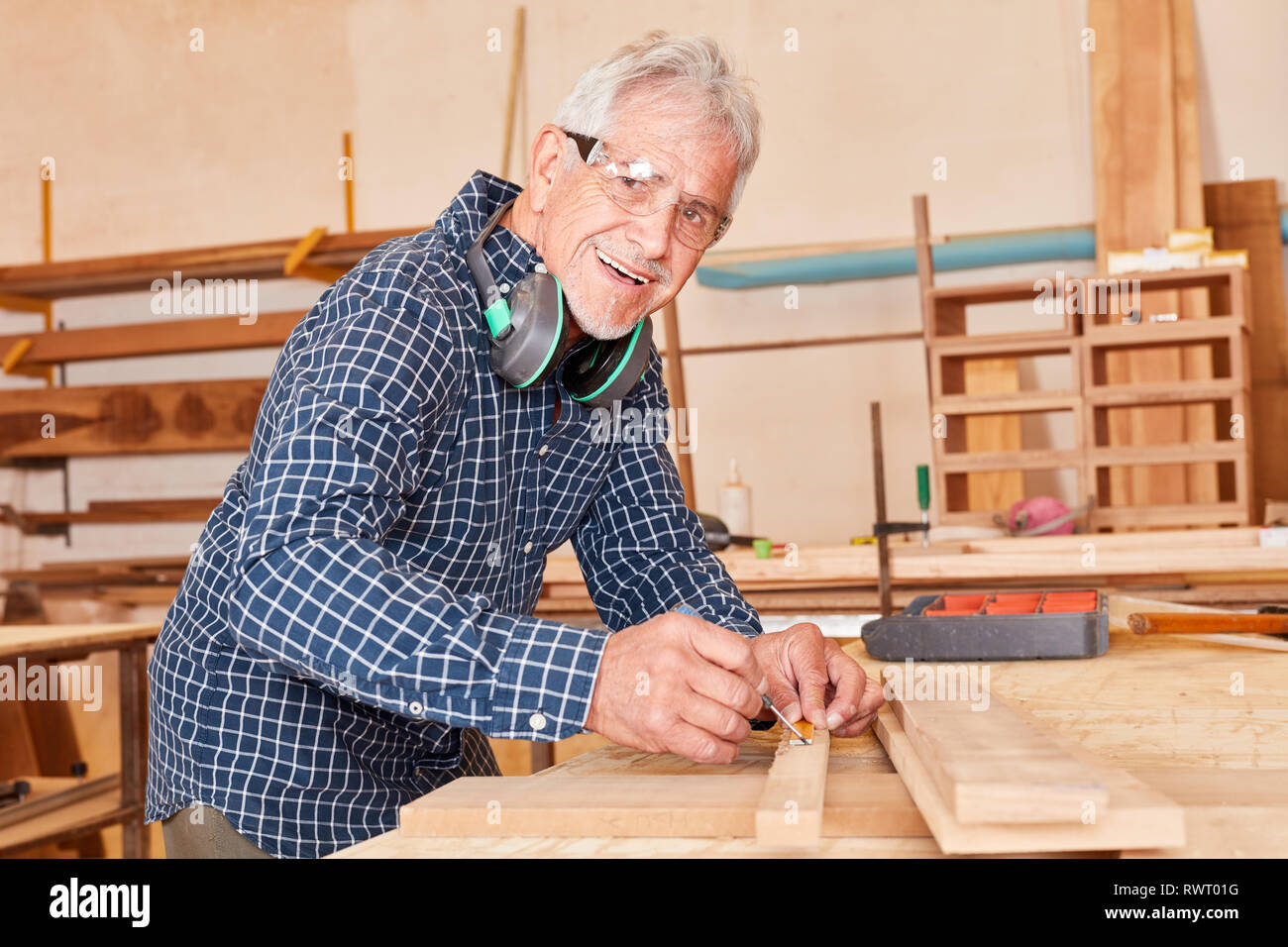 Senior man as a carpenter with experience at the workbench when ...