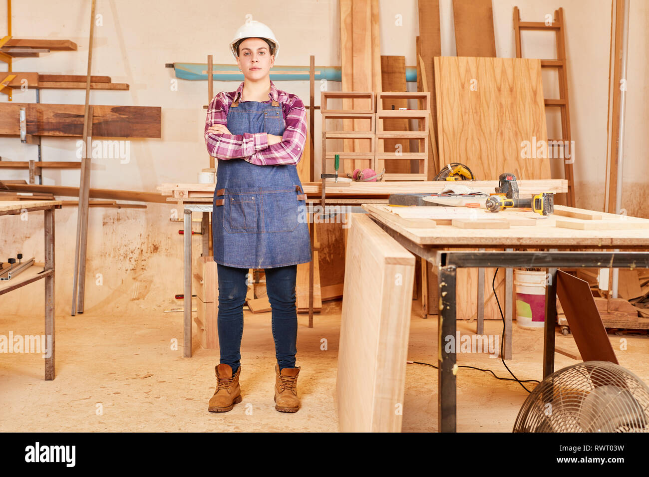 Young woman with safety helmet as a craftsman apprentice in joinery or joinery Stock Photo - Alamy