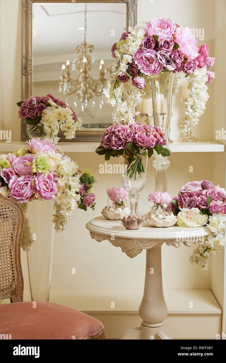 Interior of room with chair, mirror, flowers in glass vases Stock Photo ...