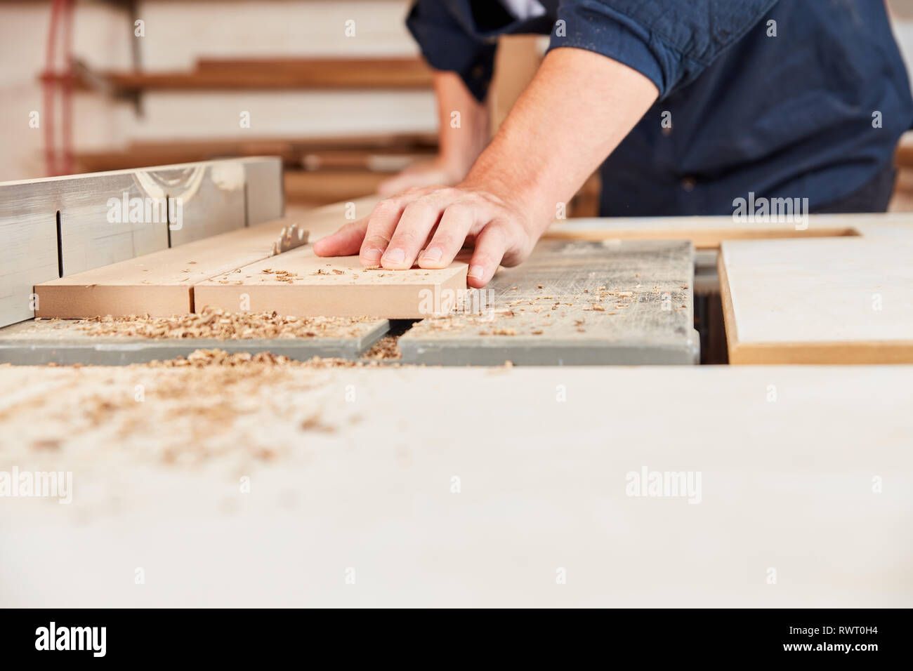 Craftsman saws wood with the circular saw in a carpentry or carpentry ...