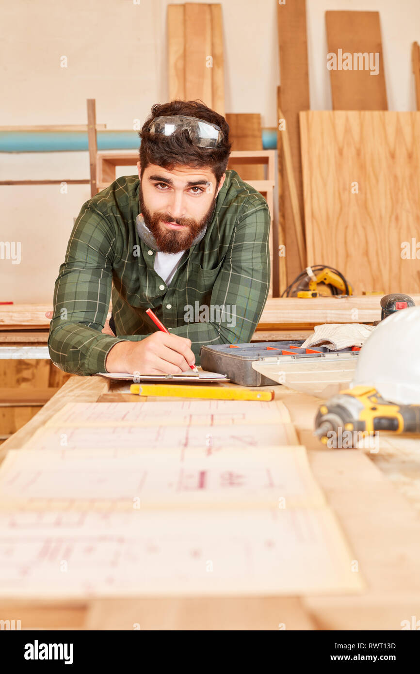 Man as a carpenter or carpenter planning a project in the joinery Stock ...