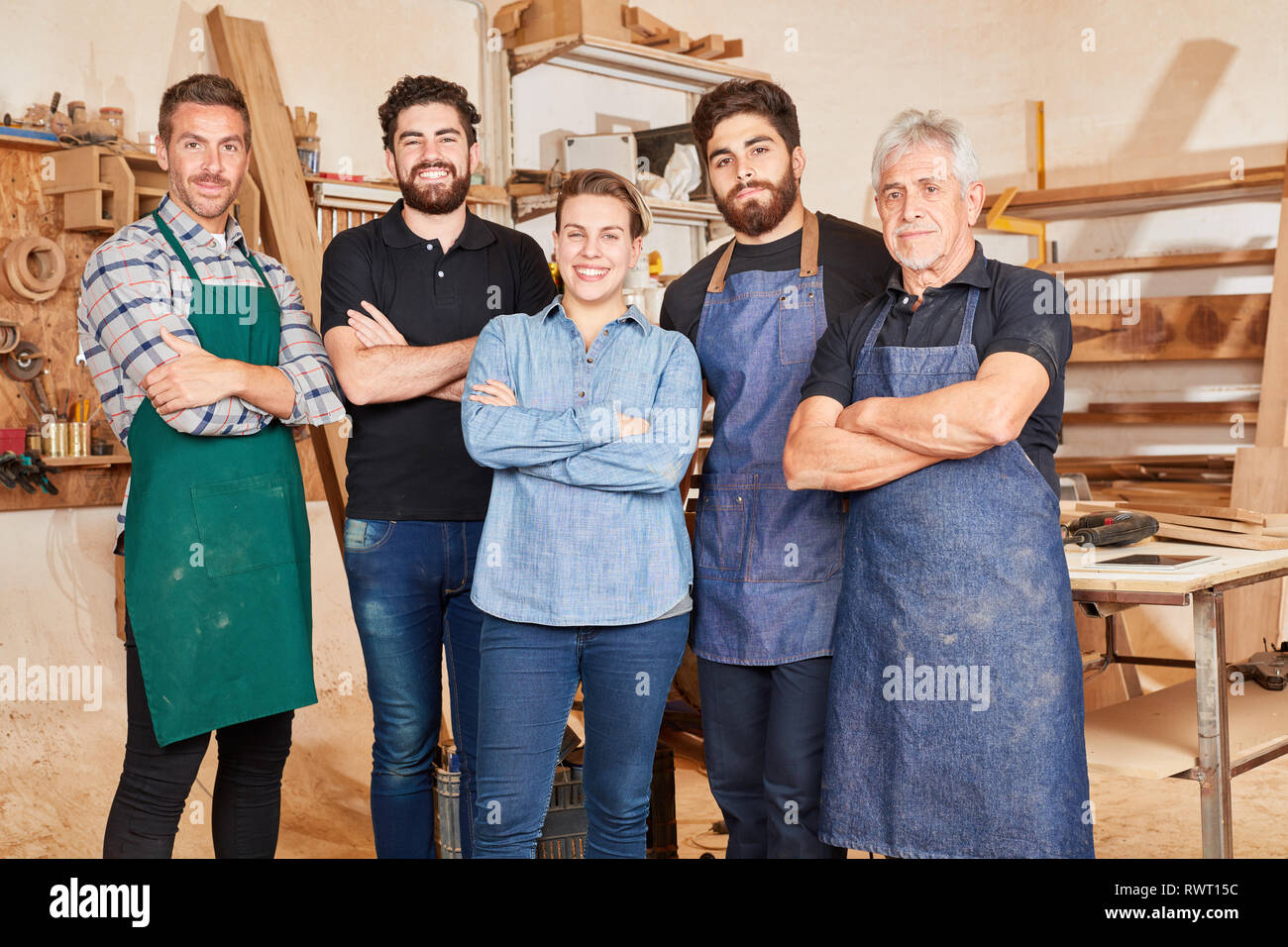 Carpenter with his trainees as a team in the workshop Stock Photo - Alamy