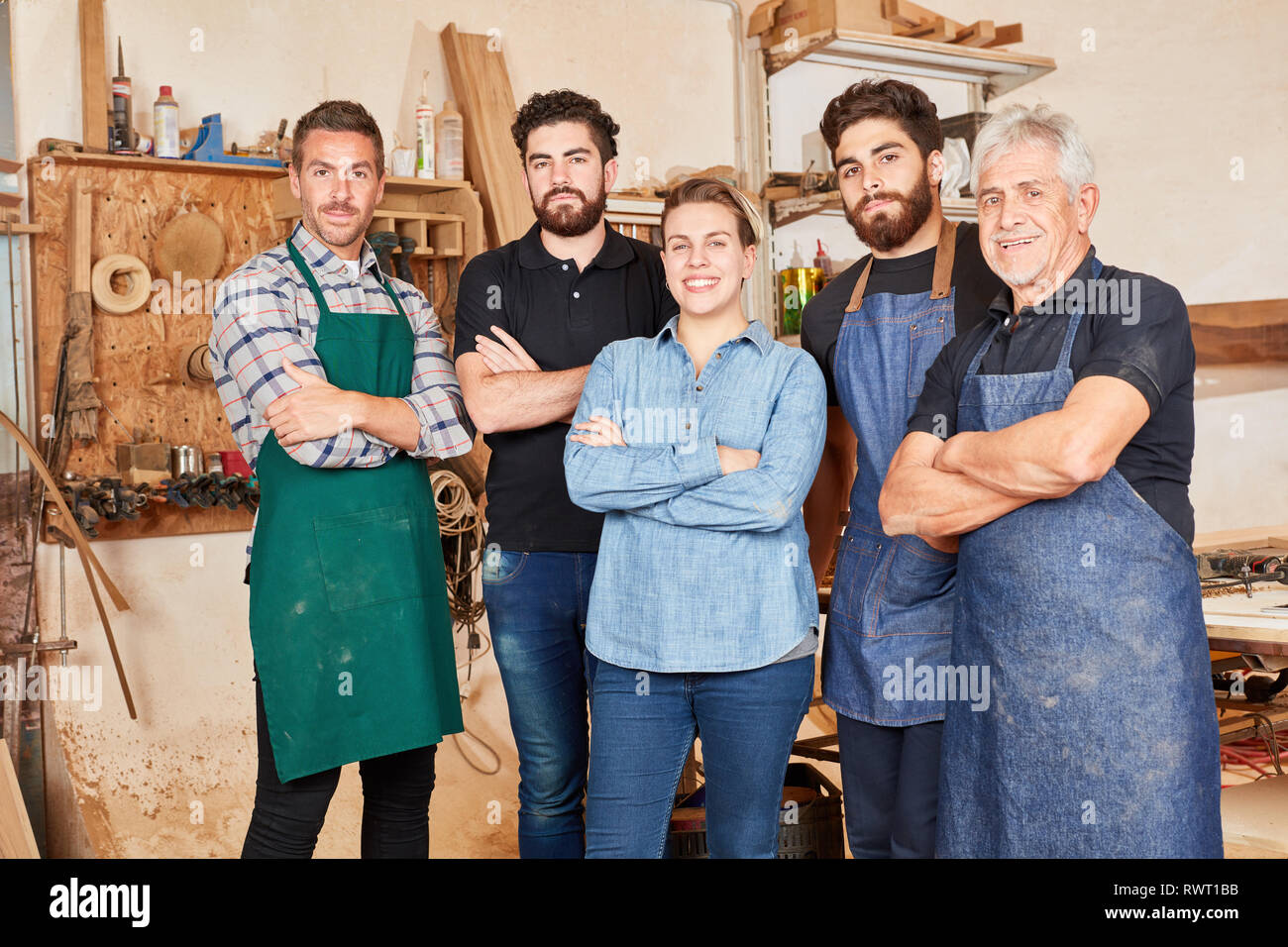 Successful craftsmen team and trainees together in the joinery ...