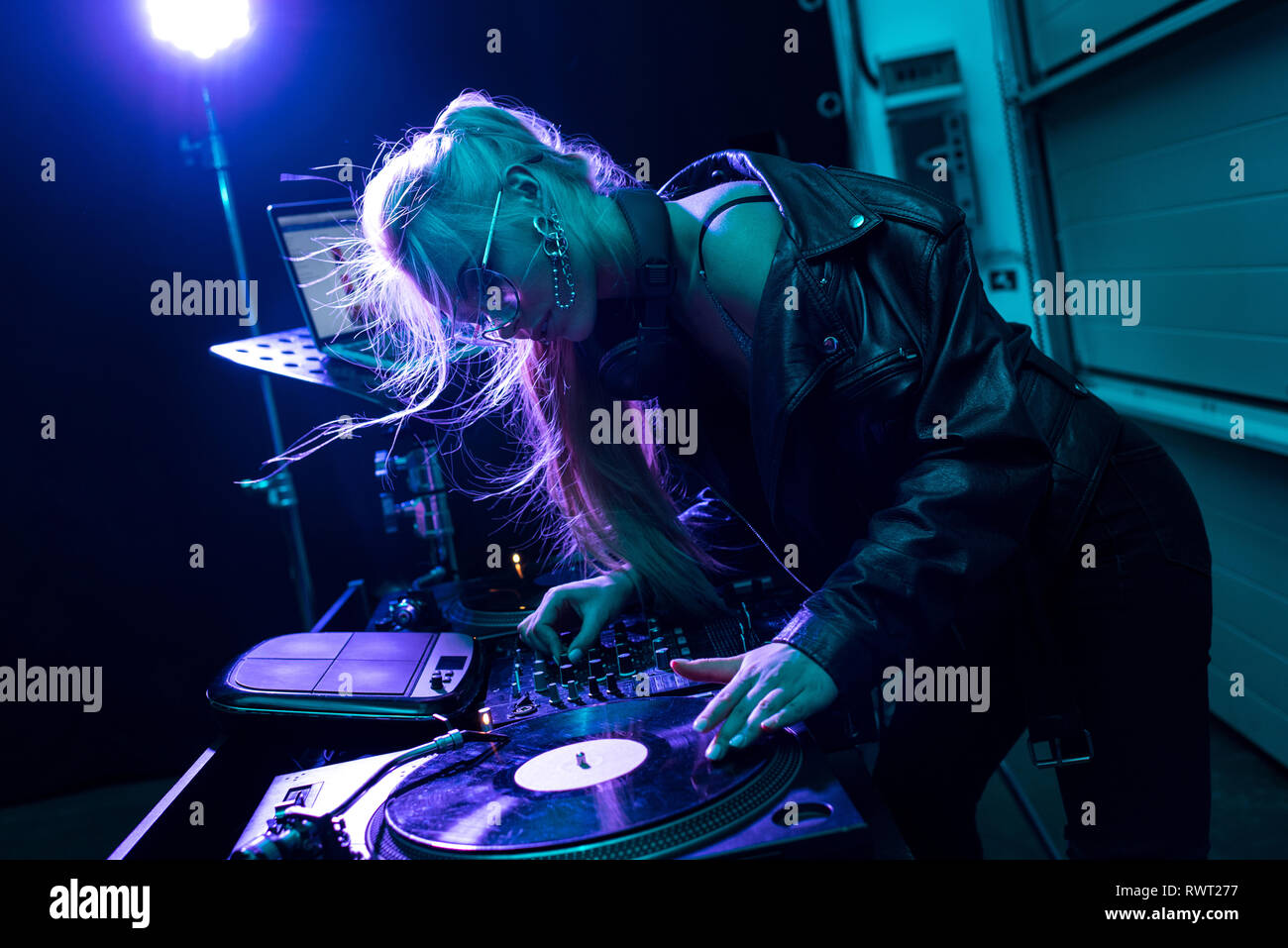 attractive blonde dj girl touching vinyl record in nightclub Stock ...