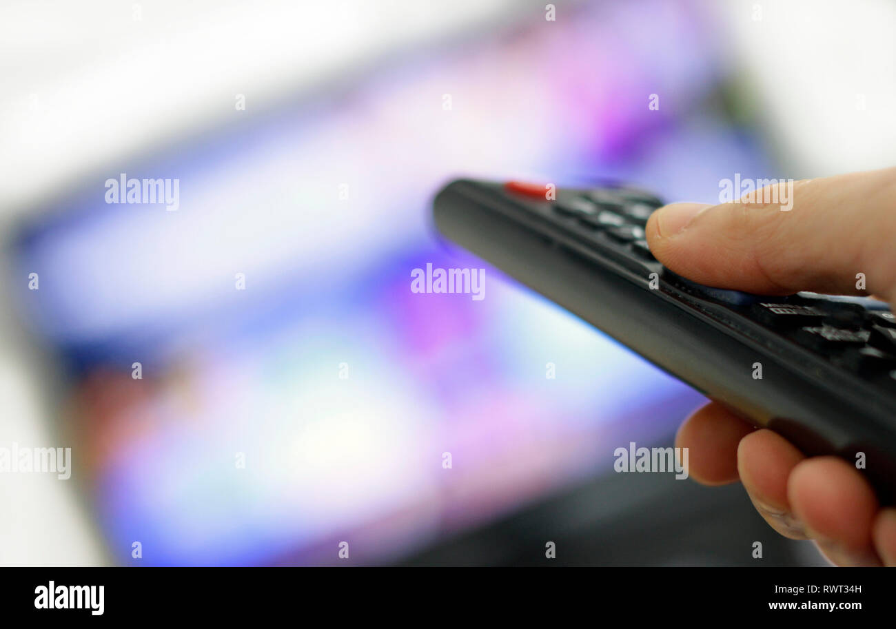 Remote control and screen - binge watching the favourite TV show Stock ...