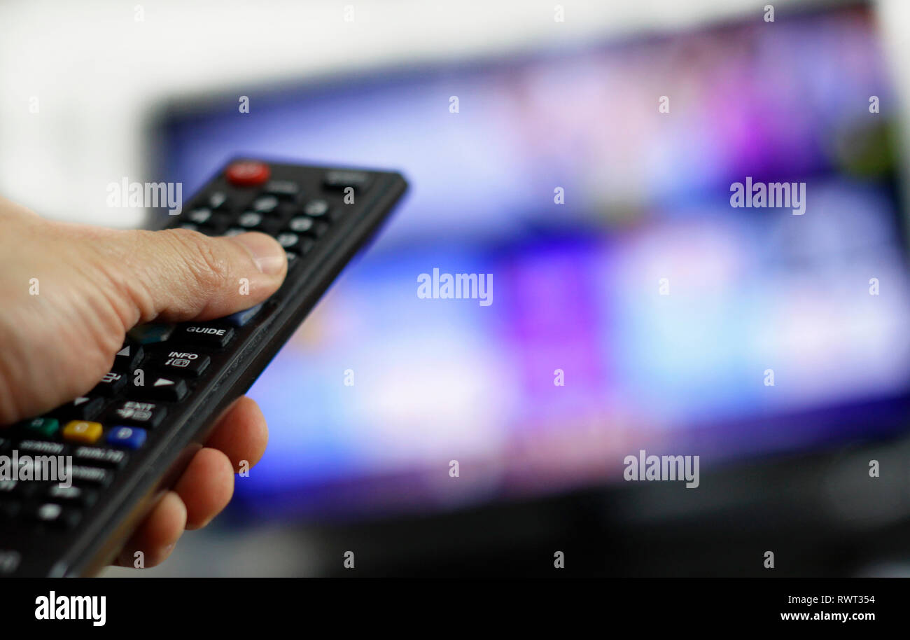 Remote control and screen - binge watching the favourite TV show Stock ...