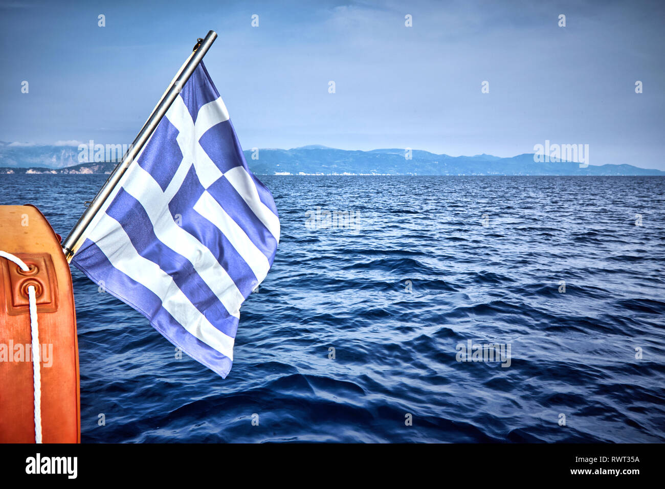 Closeup of a Greek flag waving on on stern of the ship Stock Photo - Alamy