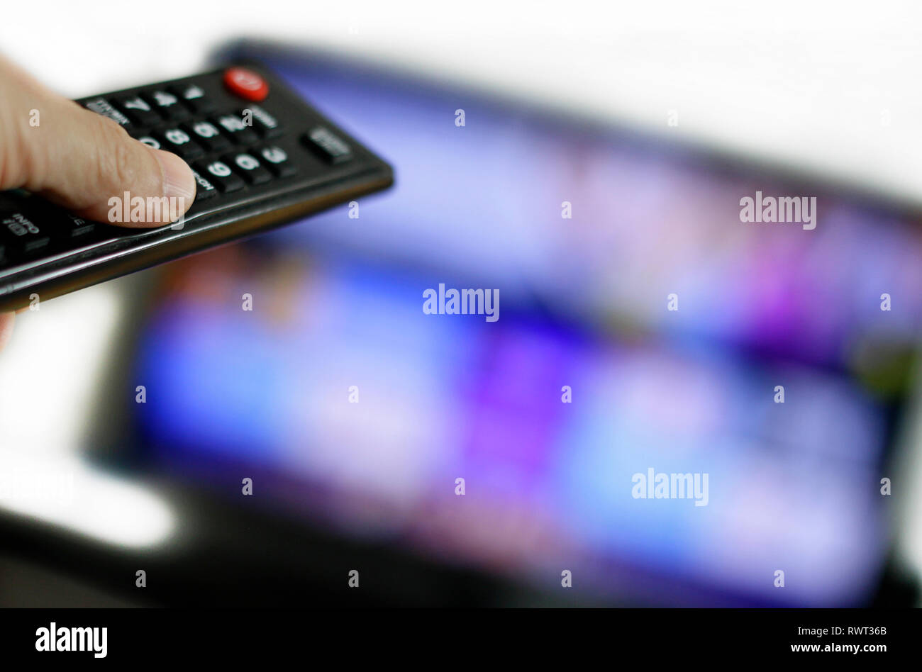 Remote control and screen - binge watching the favourite TV show Stock ...