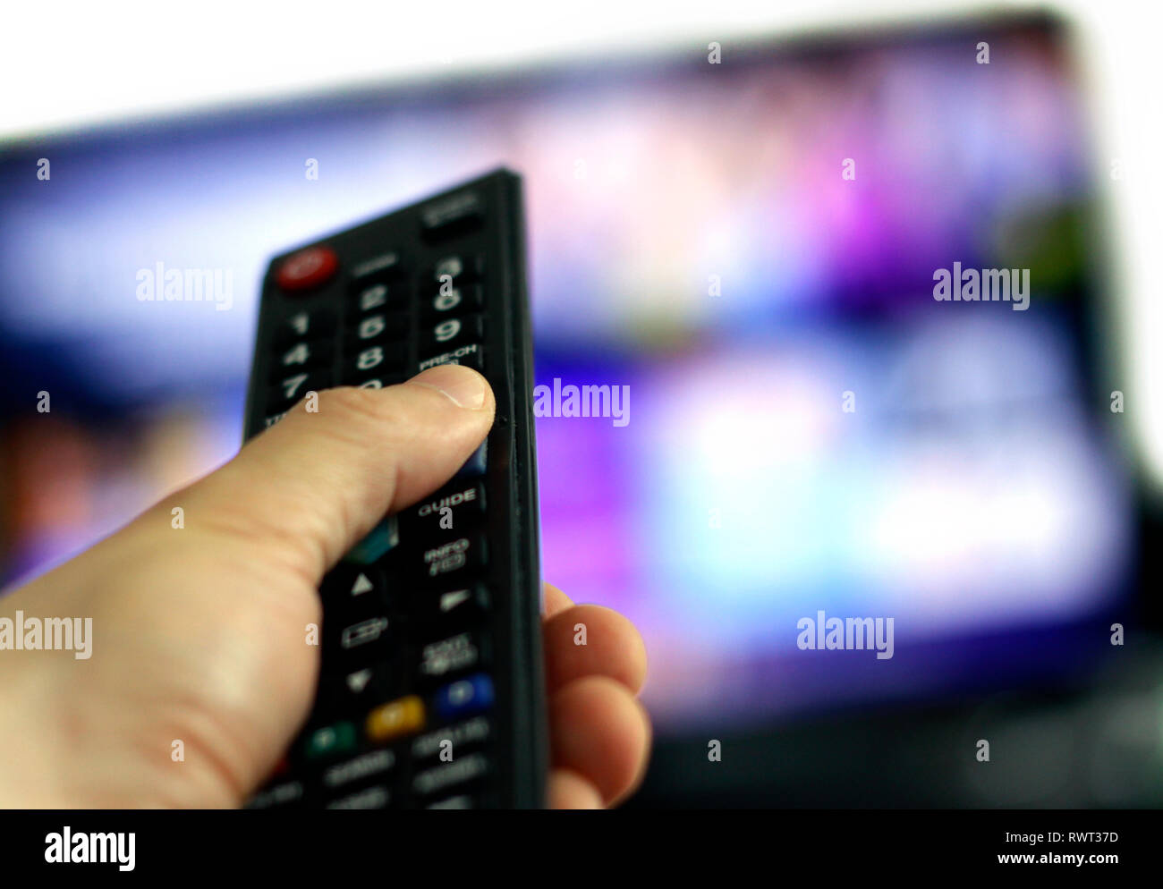 Remote control and screen - binge watching the favourite TV show Stock ...