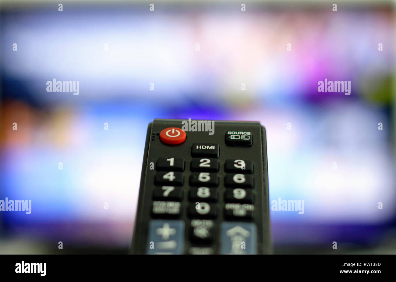 Remote control and screen - binge watching the favourite TV show Stock ...