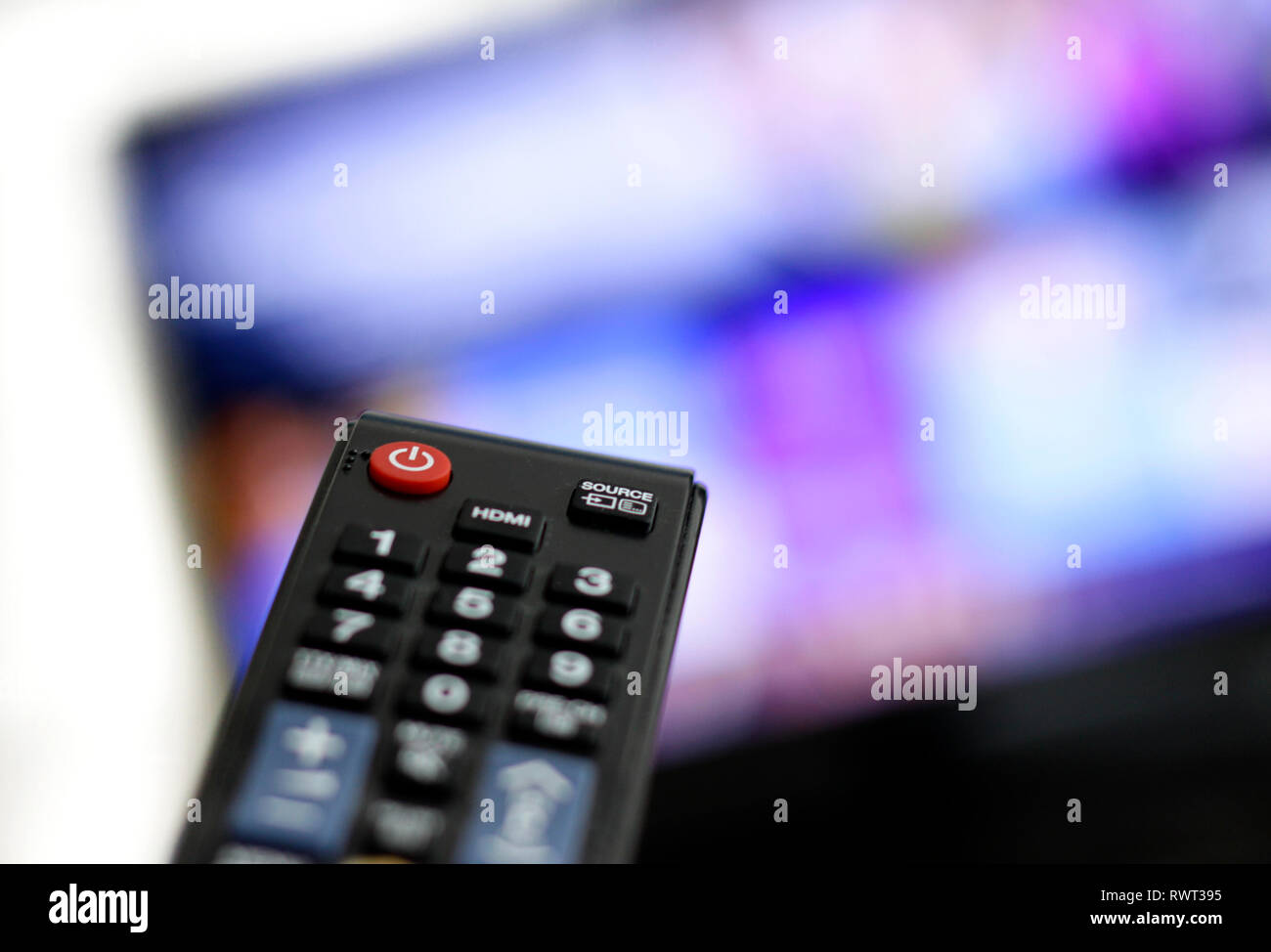 Remote control and screen - binge watching the favourite TV show Stock ...