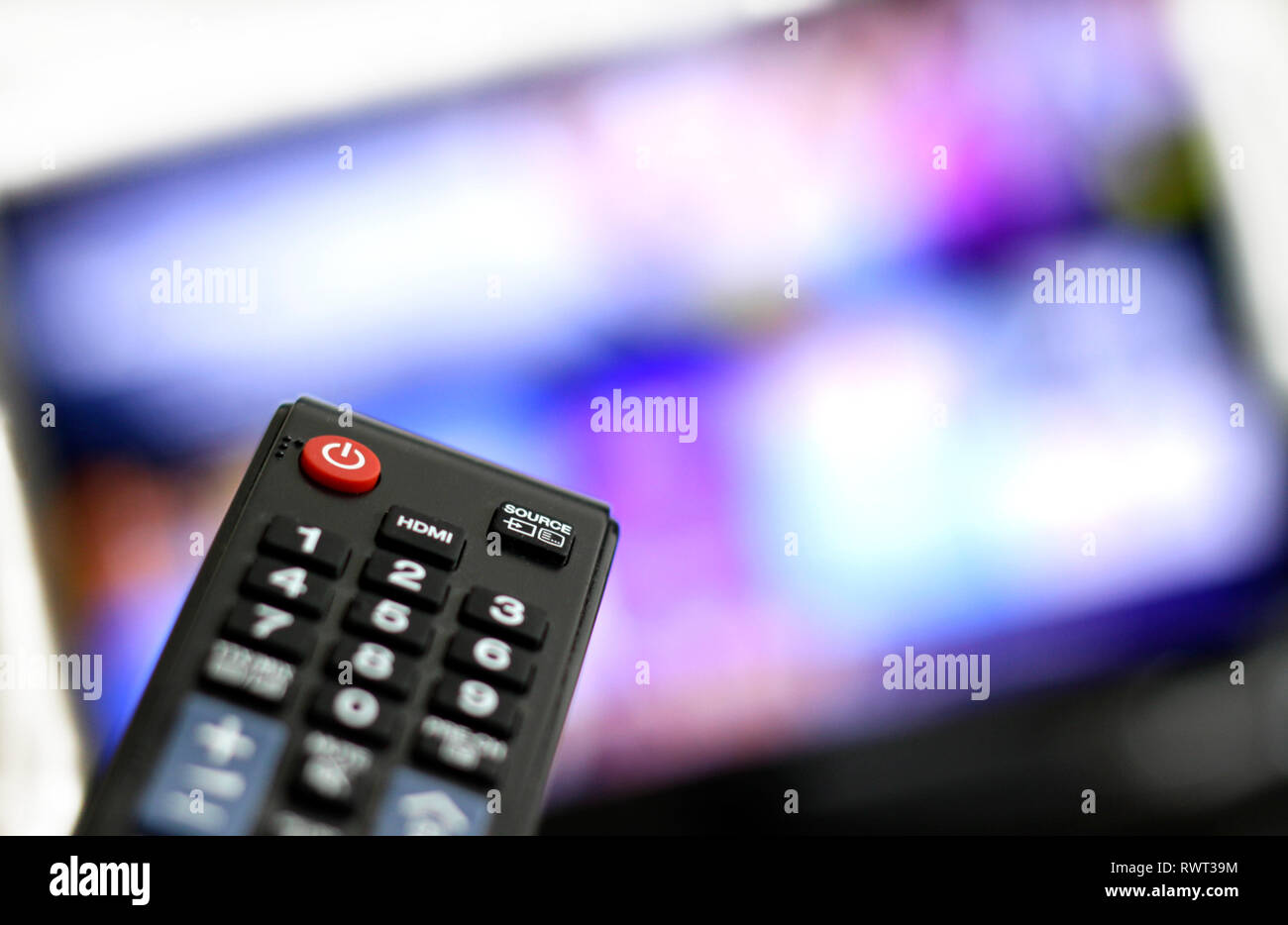 Remote control and screen - binge watching the favourite TV show Stock ...