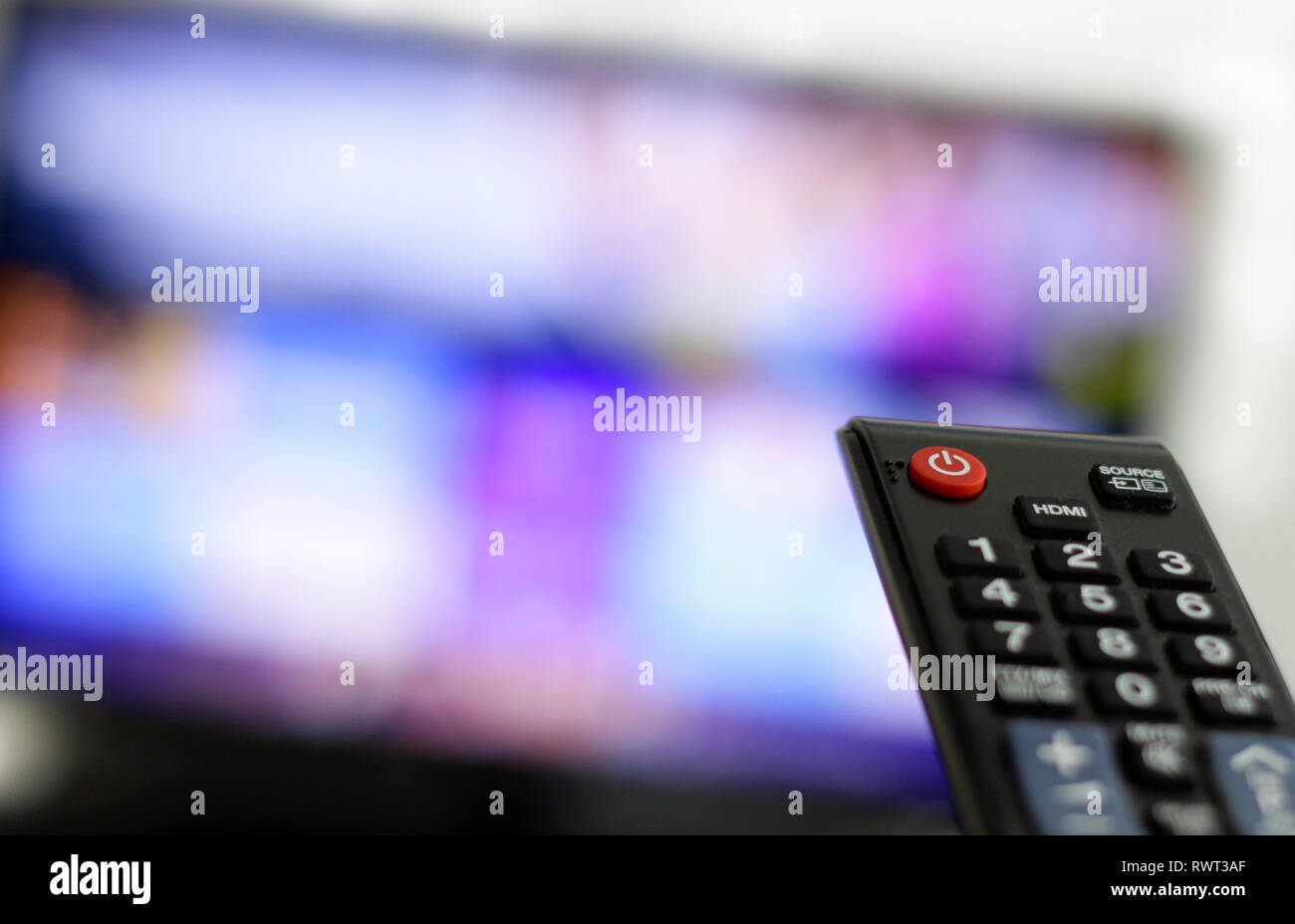 Remote control and screen - binge watching the favourite TV show Stock ...