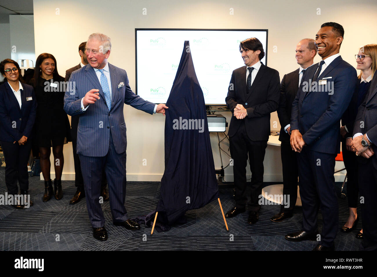 The Prince of Wales unveils a plaque during his visit to Polymateria ...