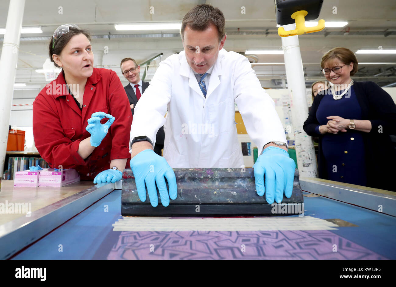 Foreign Secretary Jeremy Hunt makes a t-shirt screen print with help ...