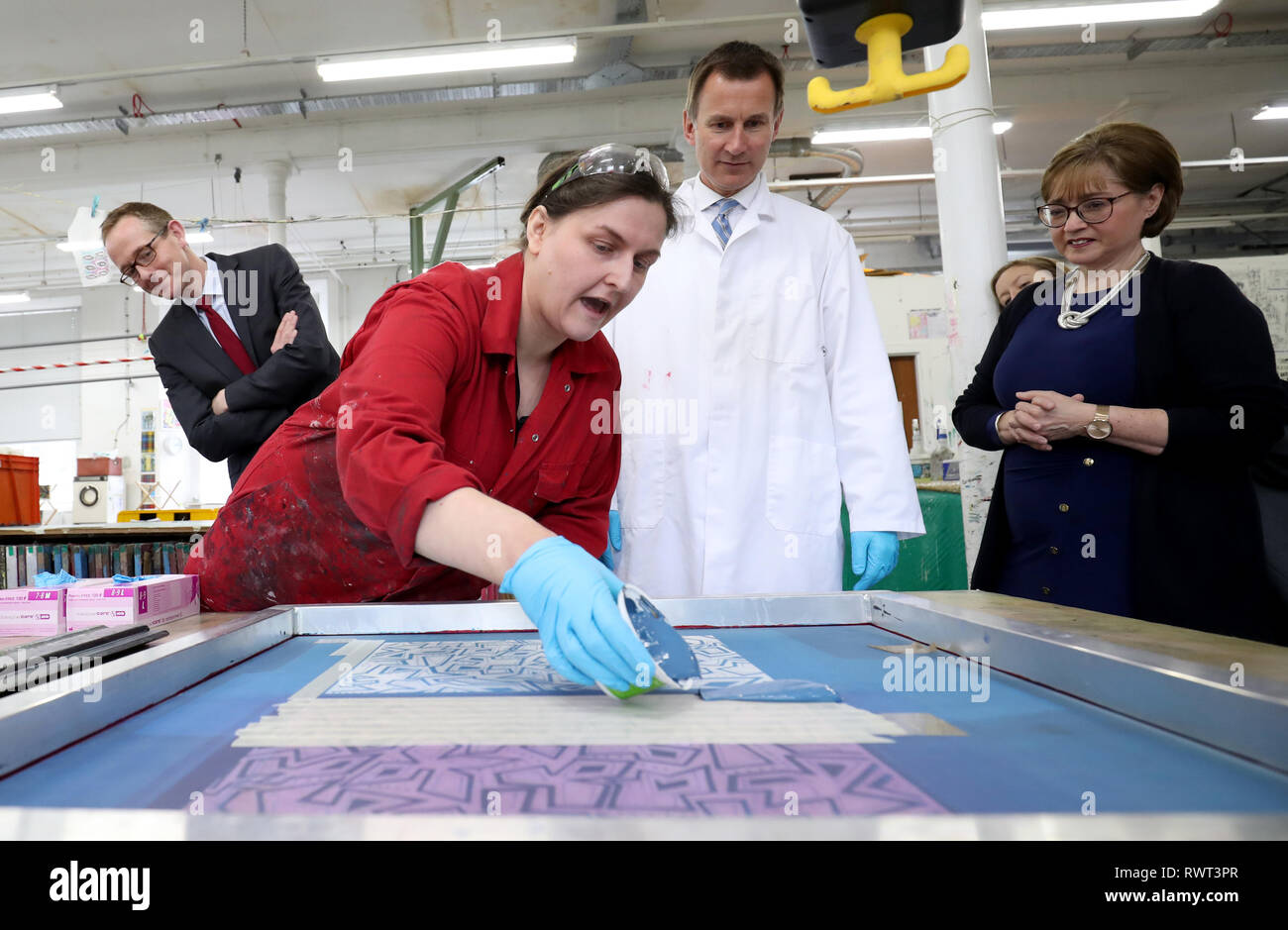 Foreign Secretary Jeremy Hunt makes a t-shirt screen print with help ...
