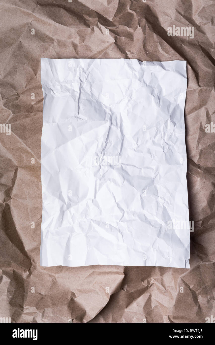 crumpled cream craft paper like a frame, and white paper, background ...
