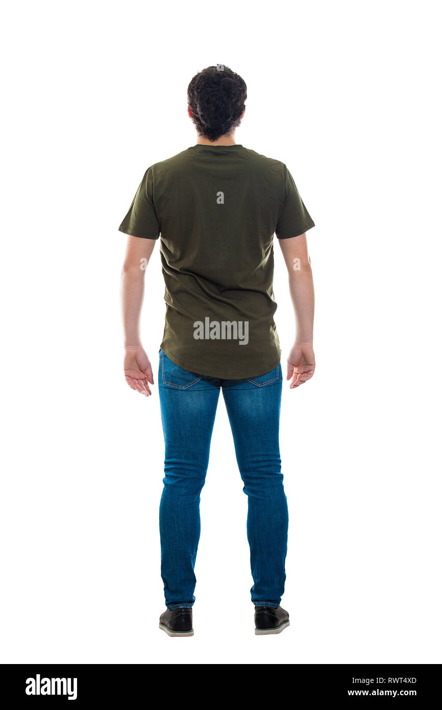 Full length rear view of casual young man standing relaxed looking ...