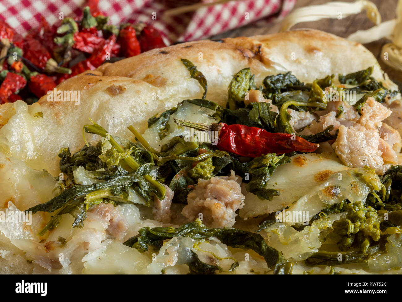 slice of Neapolitan pizza with pork sausages and friarielli broccoli ...