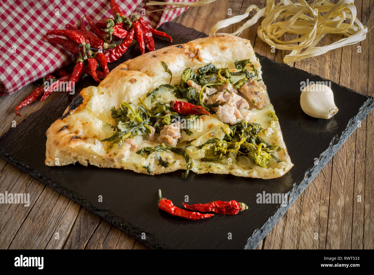 slice of Neapolitan pizza with pork sausages and friarielli broccoli ...