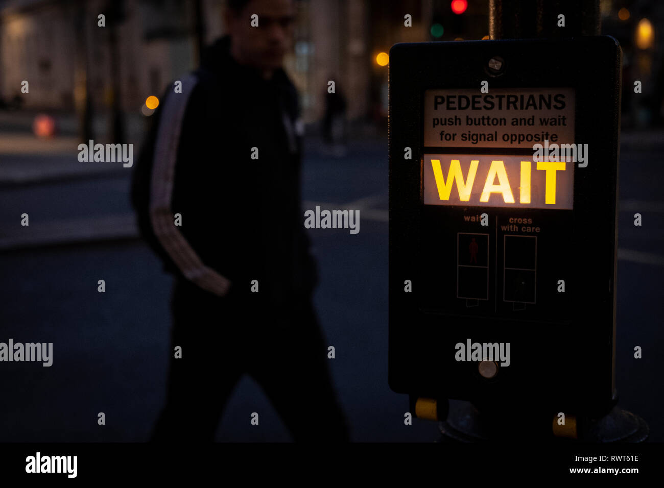 London, England - 11 June 2018: Man crossing the road with a wait ...