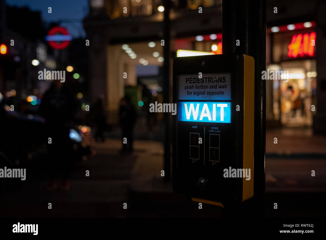 London, England - 11 June 2018: Wait sign for pedestrians lit on a ...