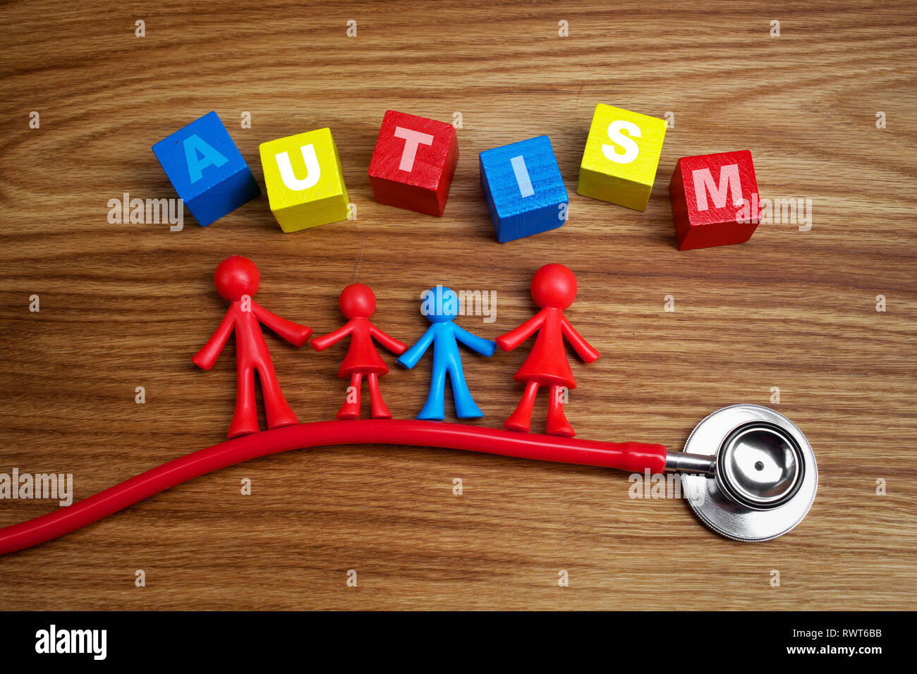 Doll family background with one different child and stethoscope. Autism ...