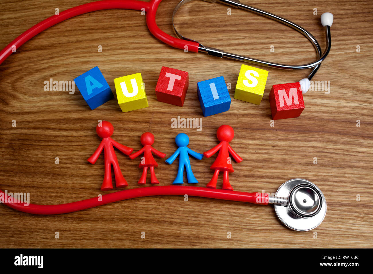 Doll family background with one different child and stethoscope. Autism ...