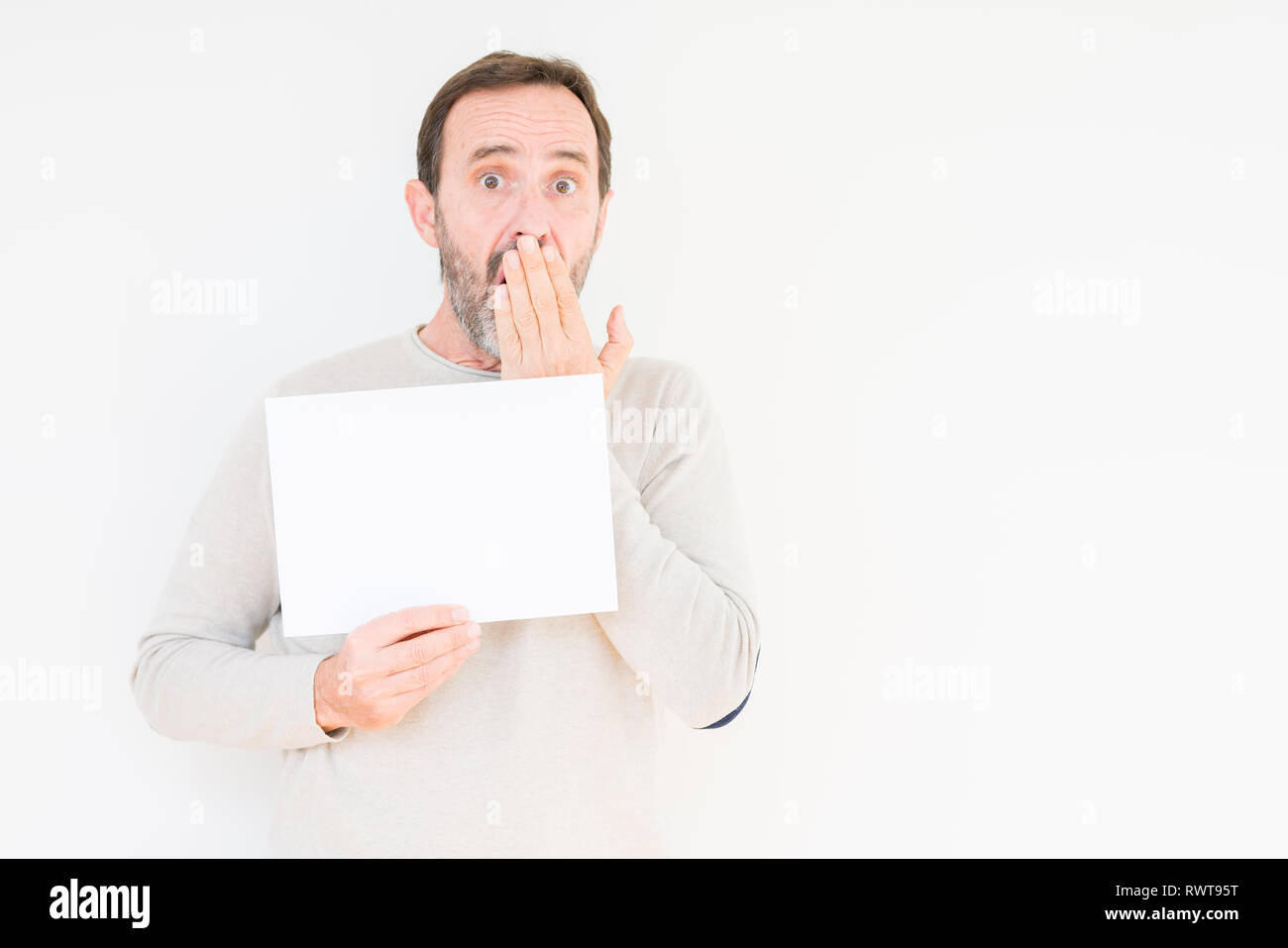 Senior man holding blank paper sheet over isolated background cover ...