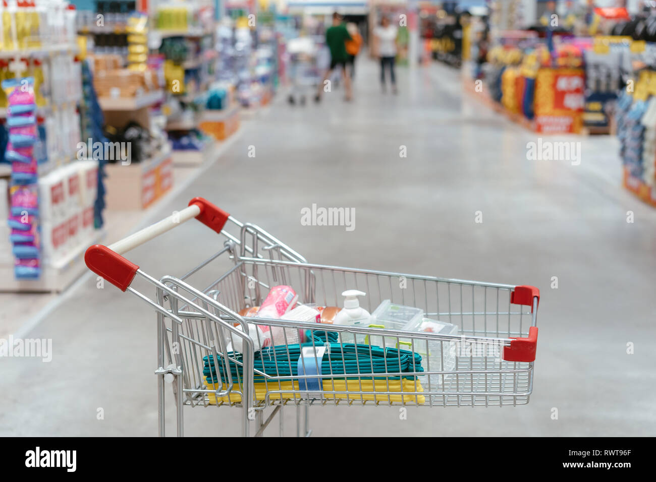 Trolley in a supermarket with various goods Stock Photo - Alamy