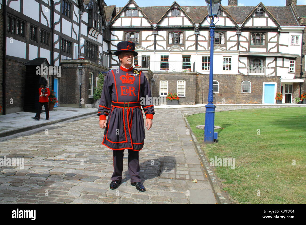 A Beefeater stands in front of the Queens House at The Tower of London ...