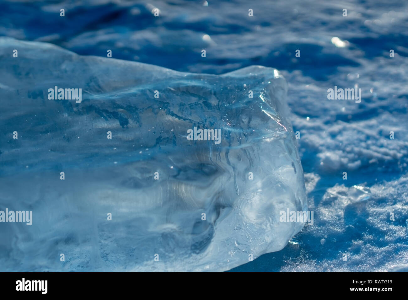 Pieces of clear blue ice of lake Baikal in the winter sunlight. Beauty ...