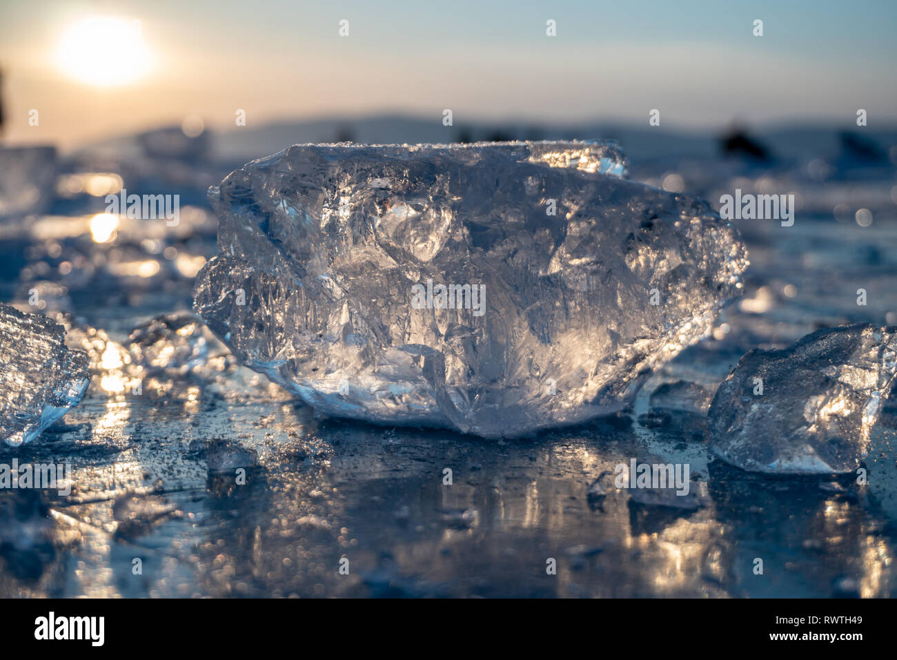 Pieces of clear blue ice of lake Baikal in the winter sunlight. Beauty ...
