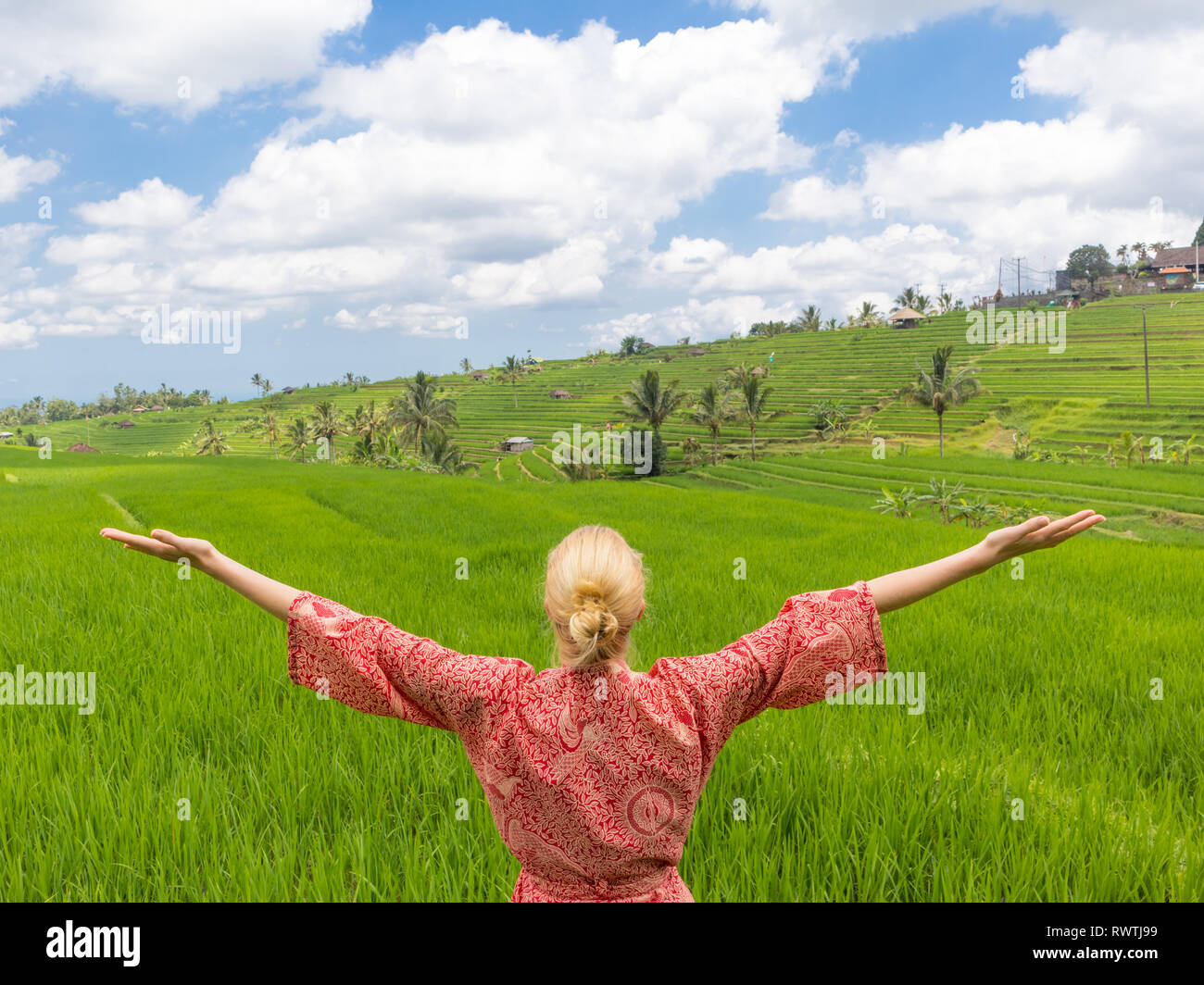 Relaxed fashionable caucasian woman wearing red asian style kimono ...