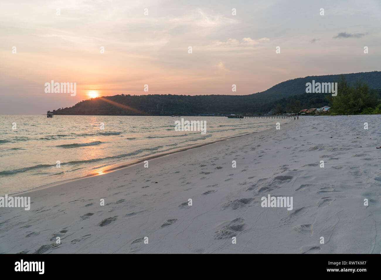 The sun is setting at the Sok San Long beach on Koh Rong Island in ...