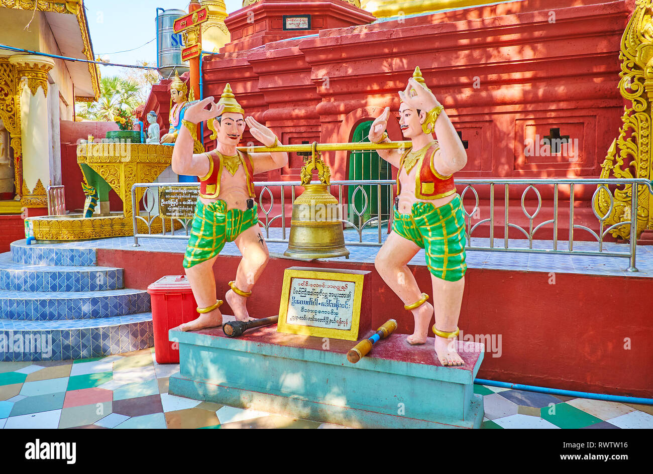 BAGO, MYANMAR - FEBRUARY 15, 2018: Traditional statues of men, carrying ...