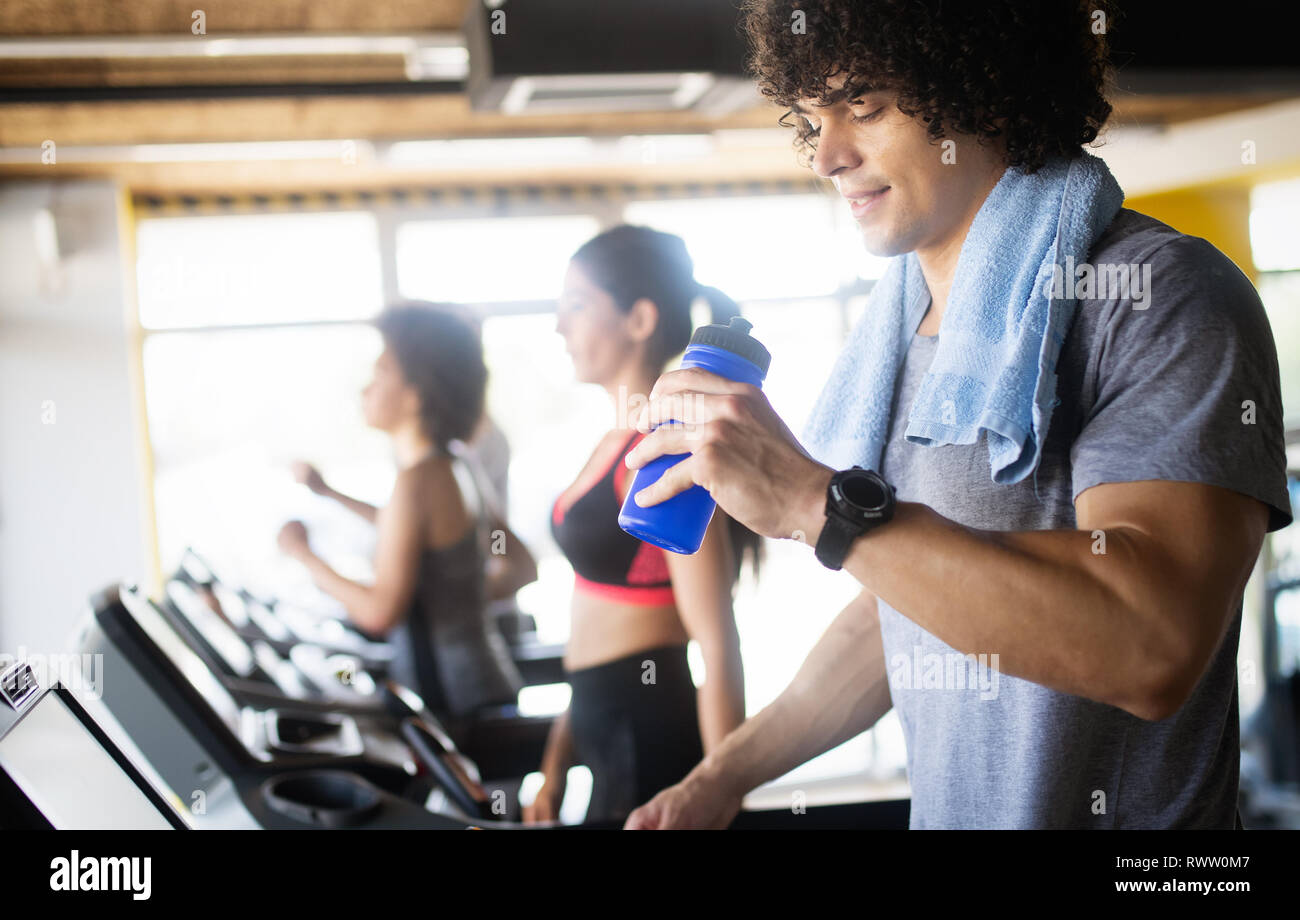 Beautiful fit people exercising together in gym Stock Photo - Alamy