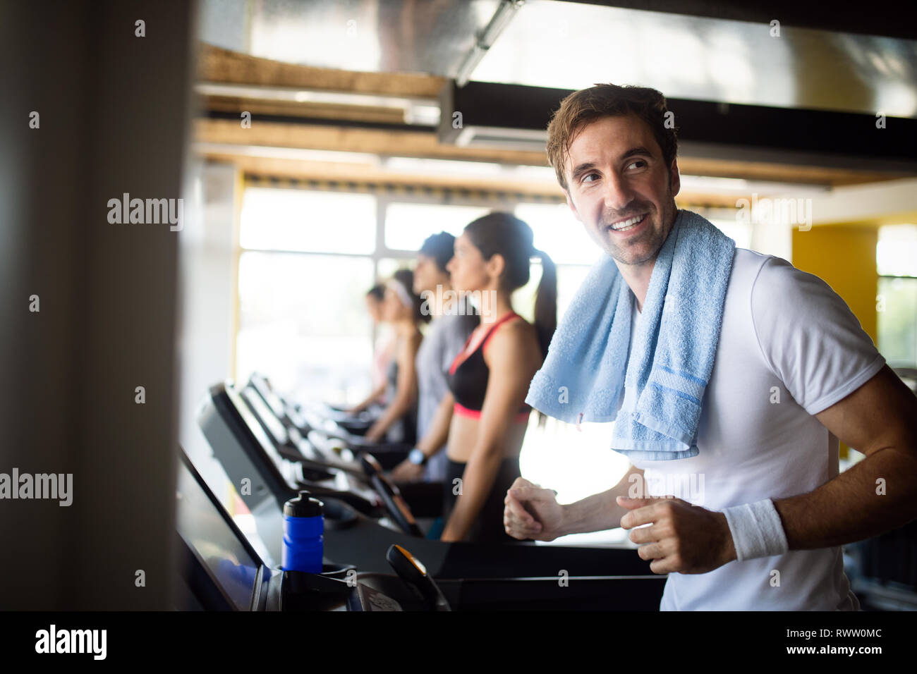Beautiful fit people exercising together in gym Stock Photo - Alamy