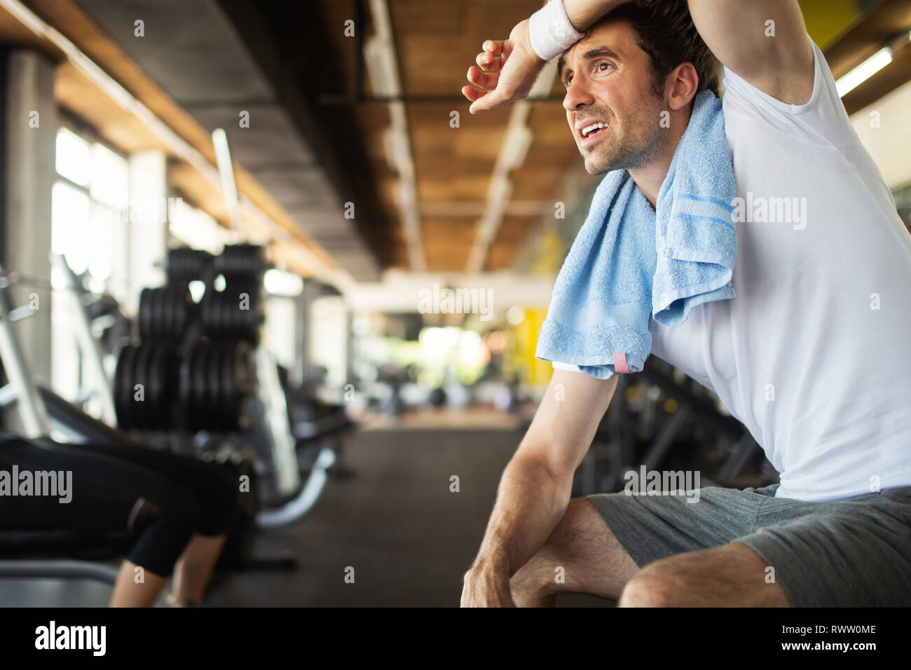 Handsome sporty man resting, having break doing exercise Stock Photo ...