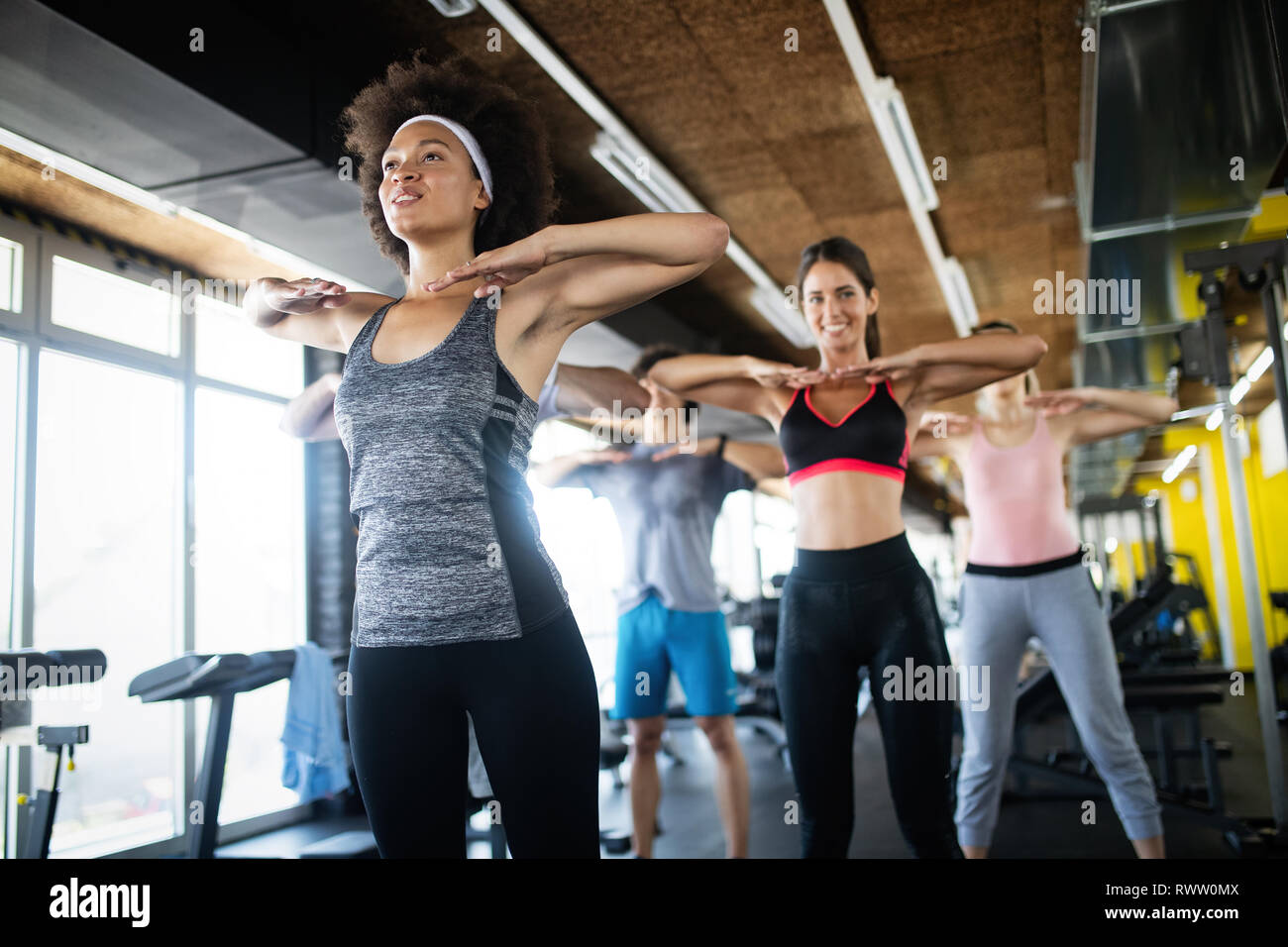 Happy gorup of healthy people training in gym Stock Photo - Alamy