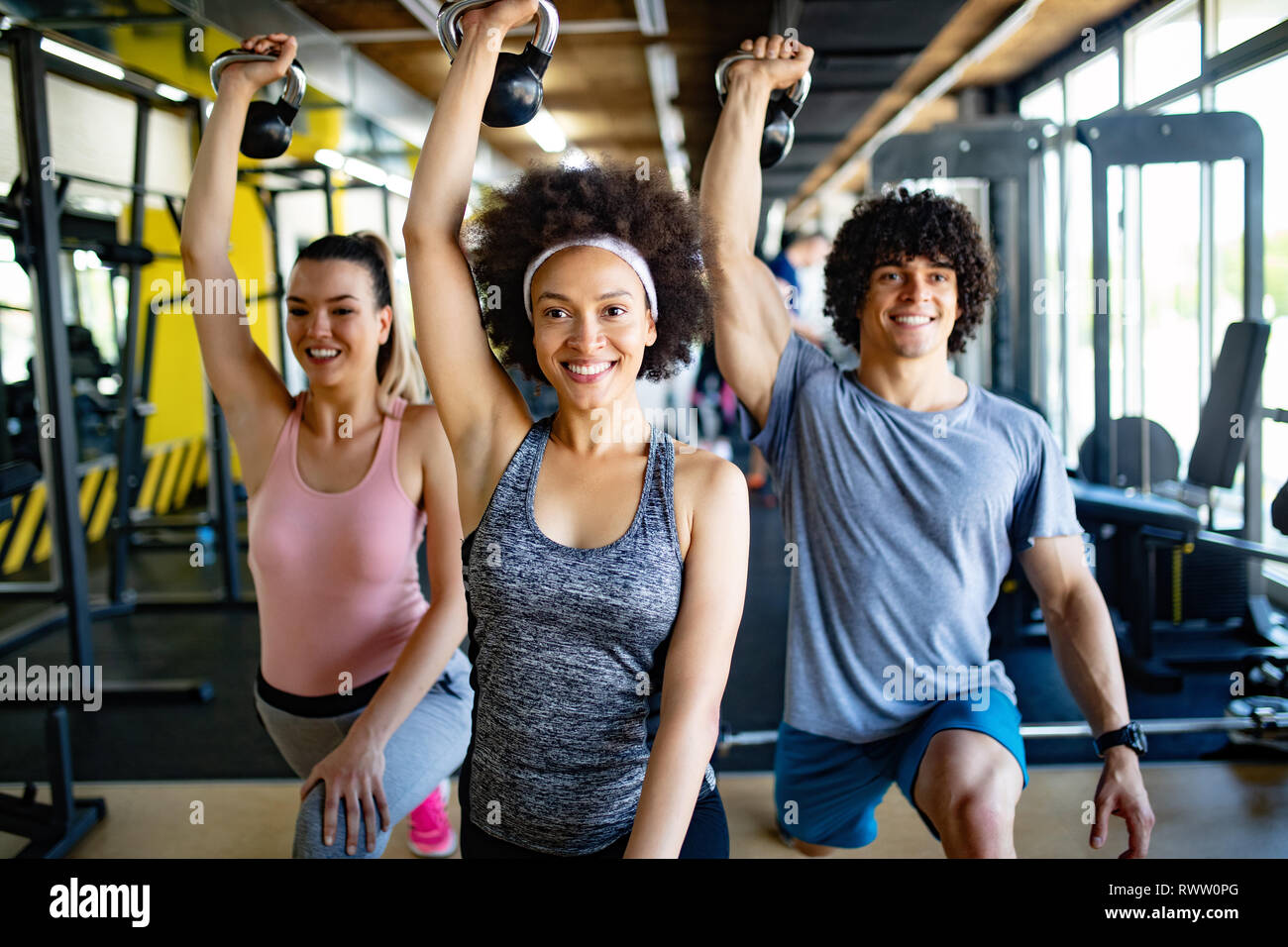 Group of young people doing exercises in gym Stock Photo - Alamy