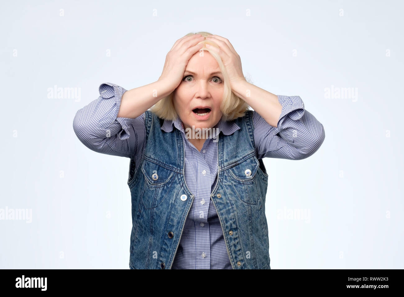 Anxious elderly blonde woman having frustrated stressed expression ...