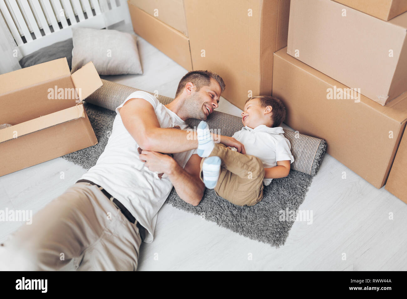 Moving concept, Father and his son moving into their new home Stock ...