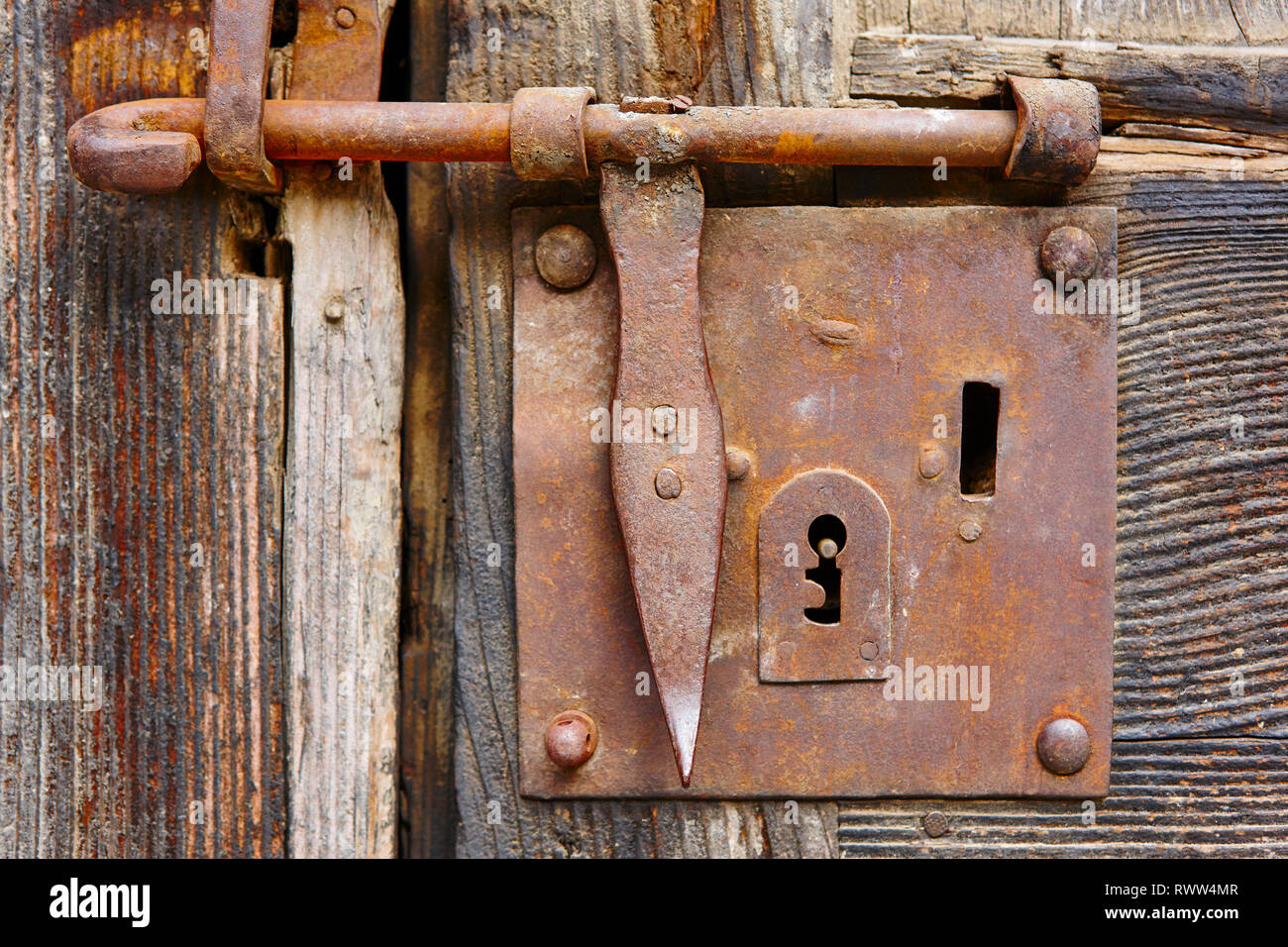 Old rusty door lock on an antique wooden door. Horizontal Stock Photo ...