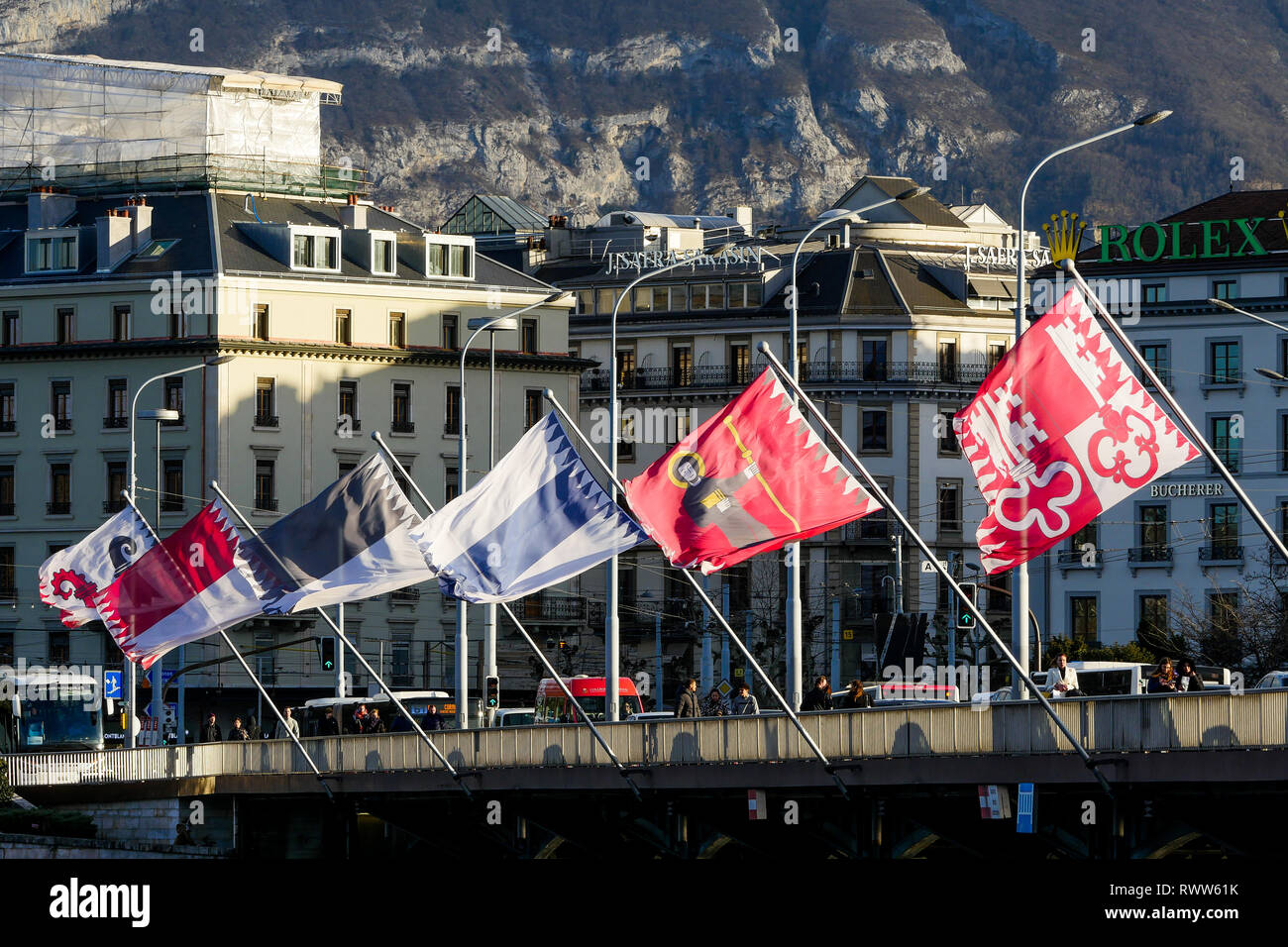 Flags of Swiss cantons fly in the wind, Mont-Blanc Bridge, Geneva ...
