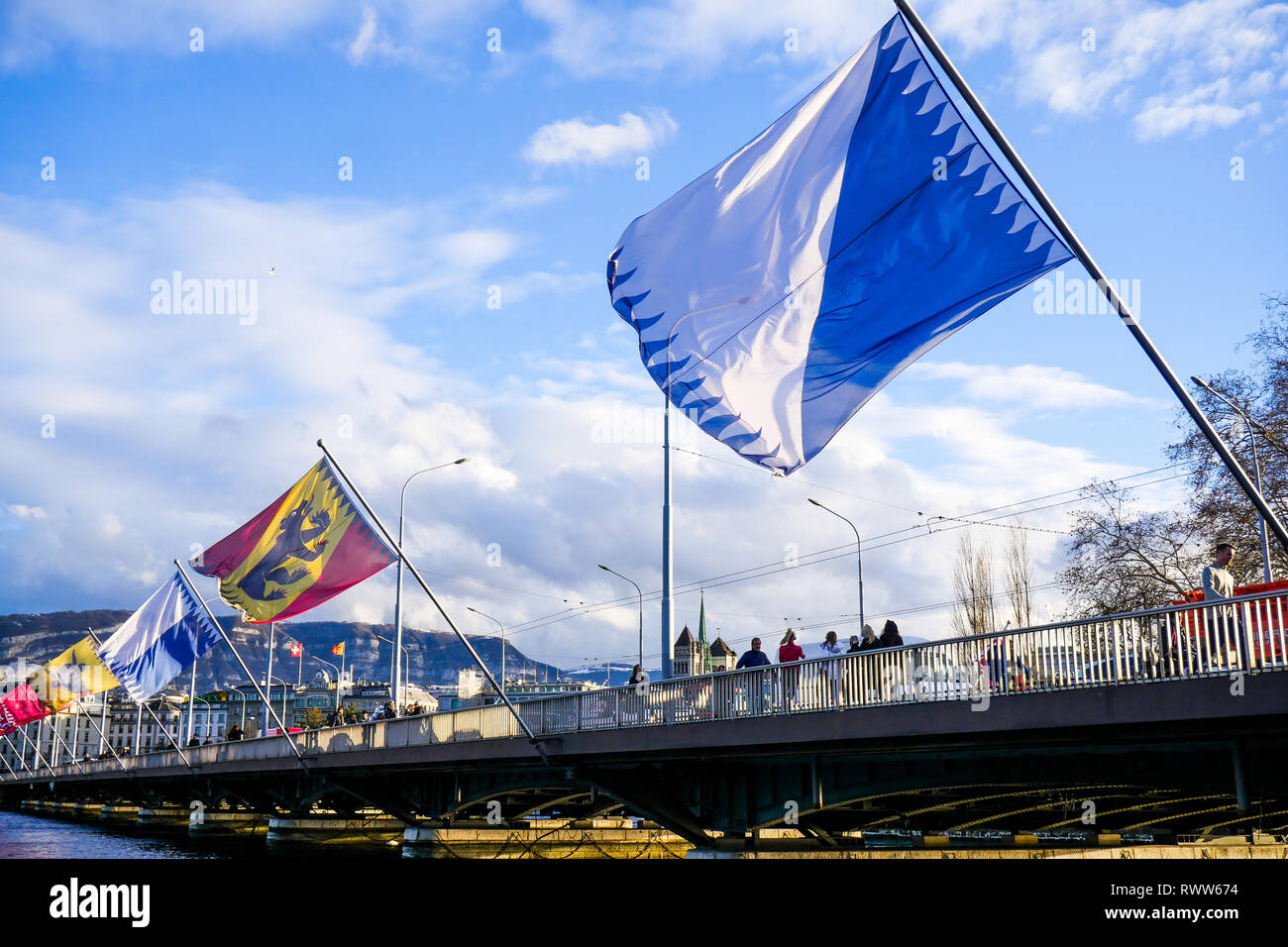 Flags of Swiss cantons fly in the wind, Mont-Blanc Bridge, Geneva ...