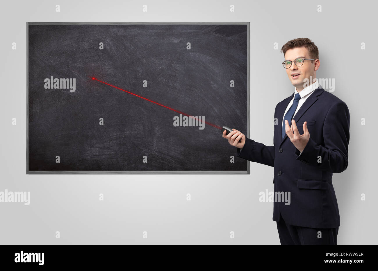 Handsome young teacher with laser pointer teaching Stock Photo - Alamy