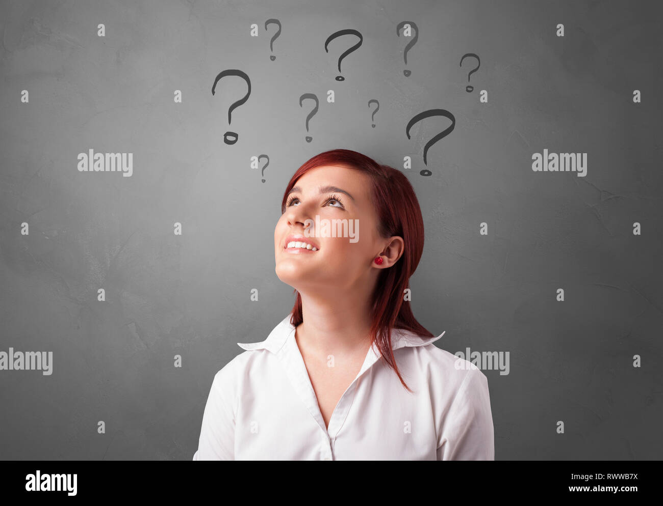 Person with question marks around face Stock Photo - Alamy